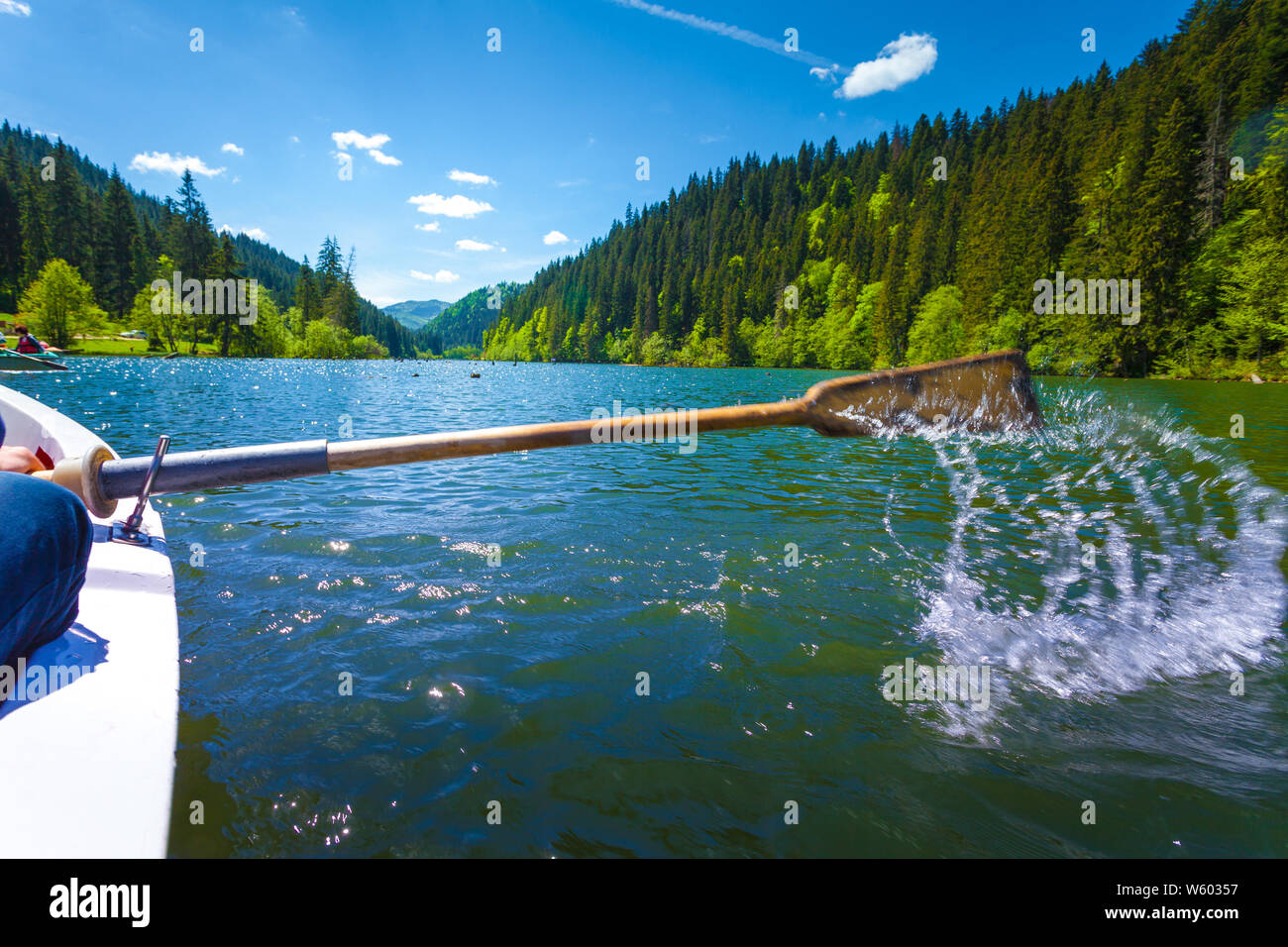 Tourist boat on a mounain lake rowing fast, making a splash Stock Photo ...