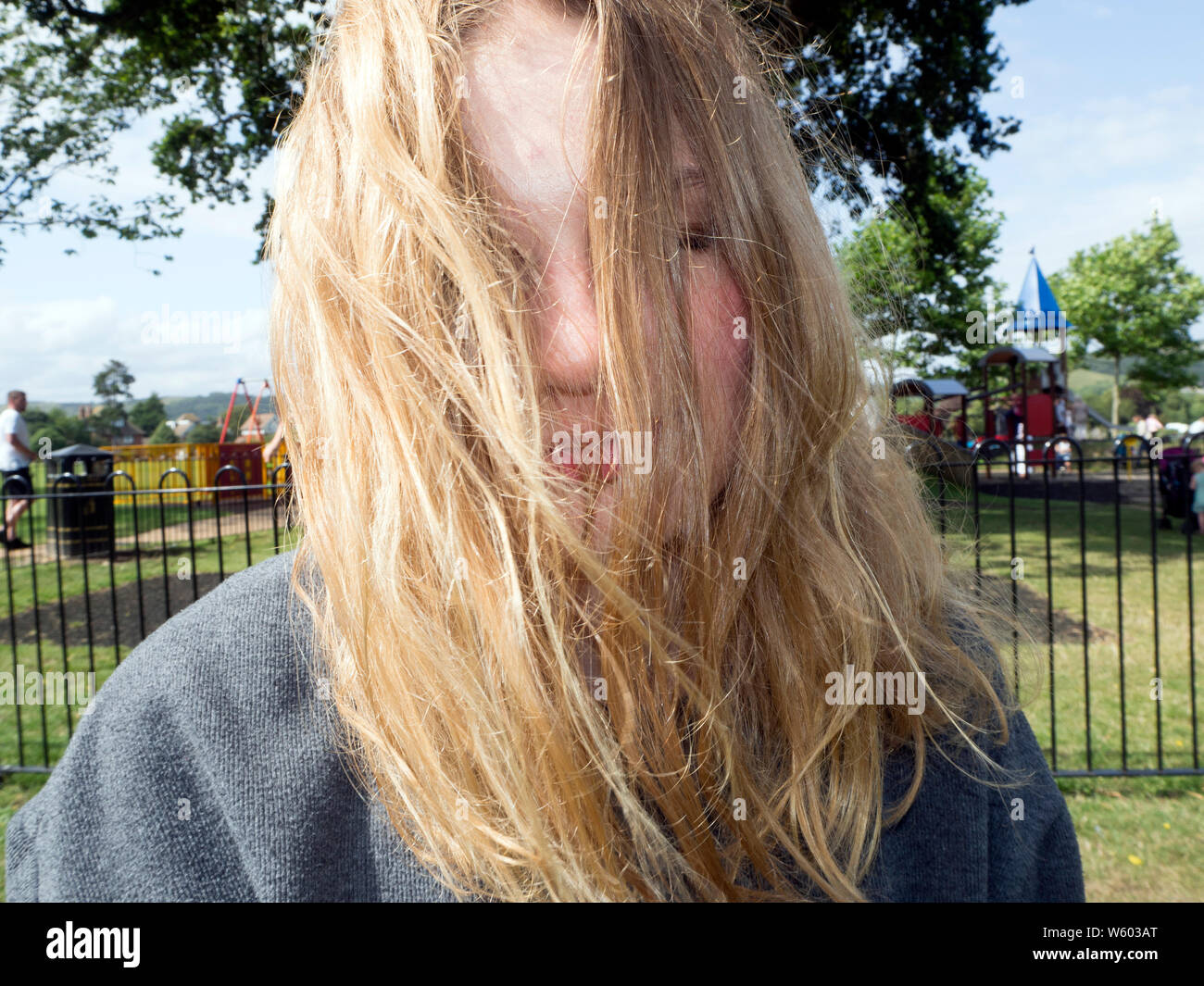 Blonde Teenage girl messing around with her messy hair Stock Photo - Alamy