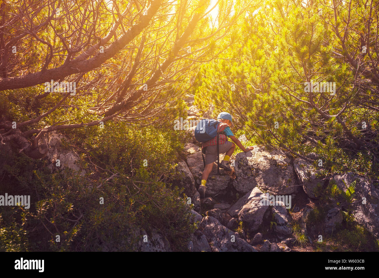 Overcoming obstacles conceptual photo kid climbing over big rocks Stock ...