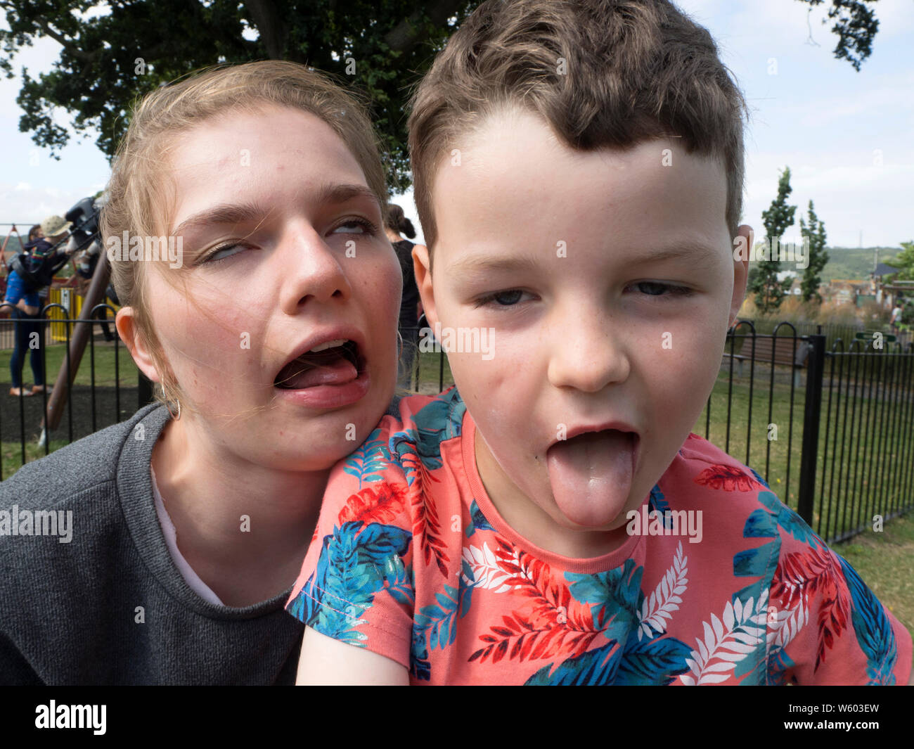 chidlren pulling faces Stock Photo - Alamy