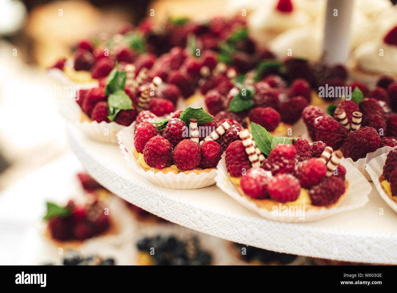 Tasty raspberry pastries on a buffet dessert table Stock Photo - Alamy