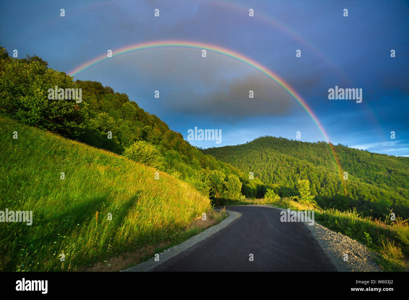 Scenic rainbow landscape on the hills in rural peaceful area Stock ...
