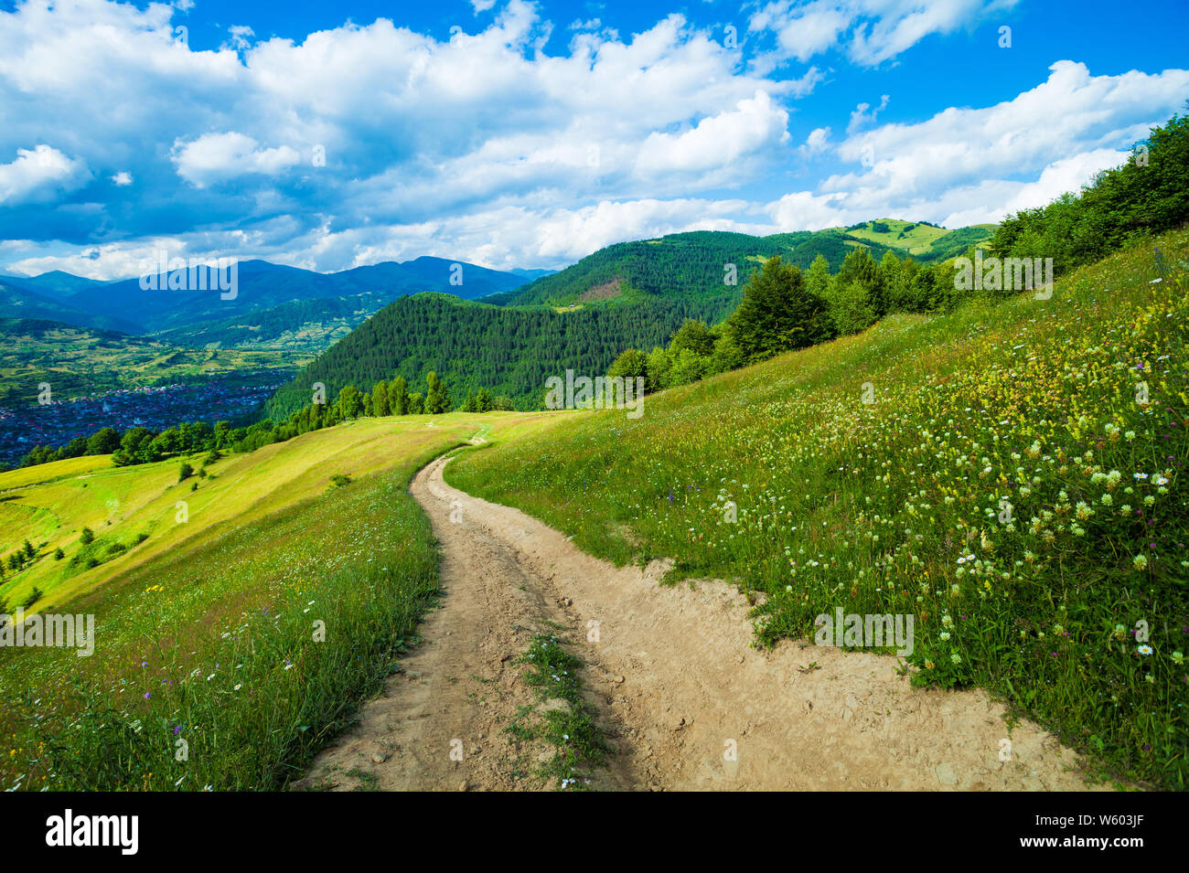 Beautiful winding road in spring rolling through the hills Stock Photo ...