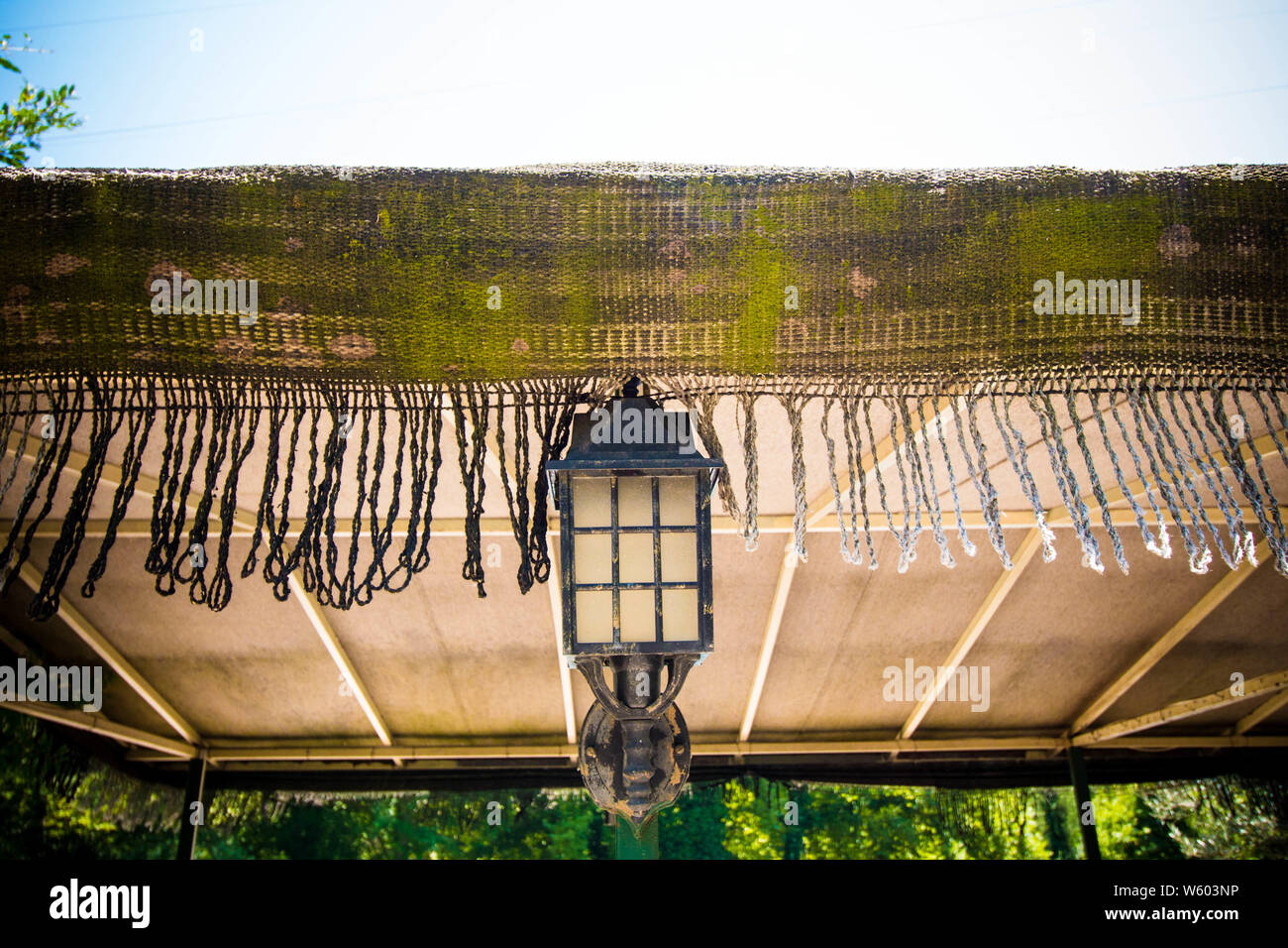 Vintage lantern on the roof of the building. Lantern and roof against ...