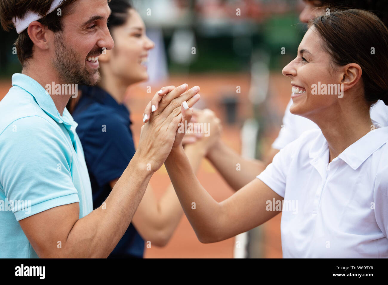 Group of tennis players giving a handshake after a match Stock Photo ...