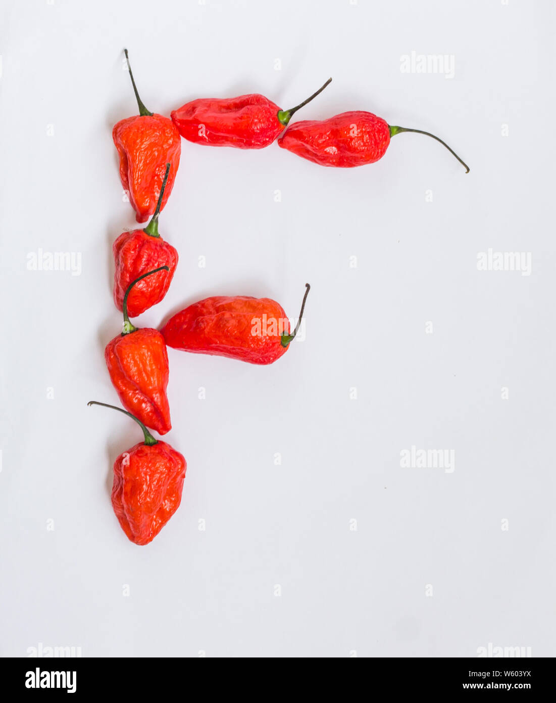 Letter F alphabet made with Ghost pepper Bhoot jolokia over white ...