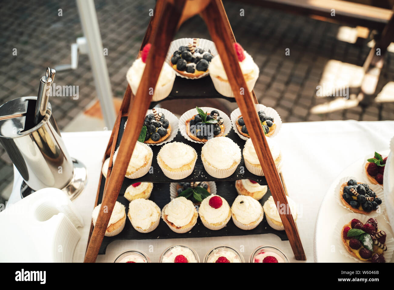 Tiered triangular wooden pastry stand Stock Photo - Alamy