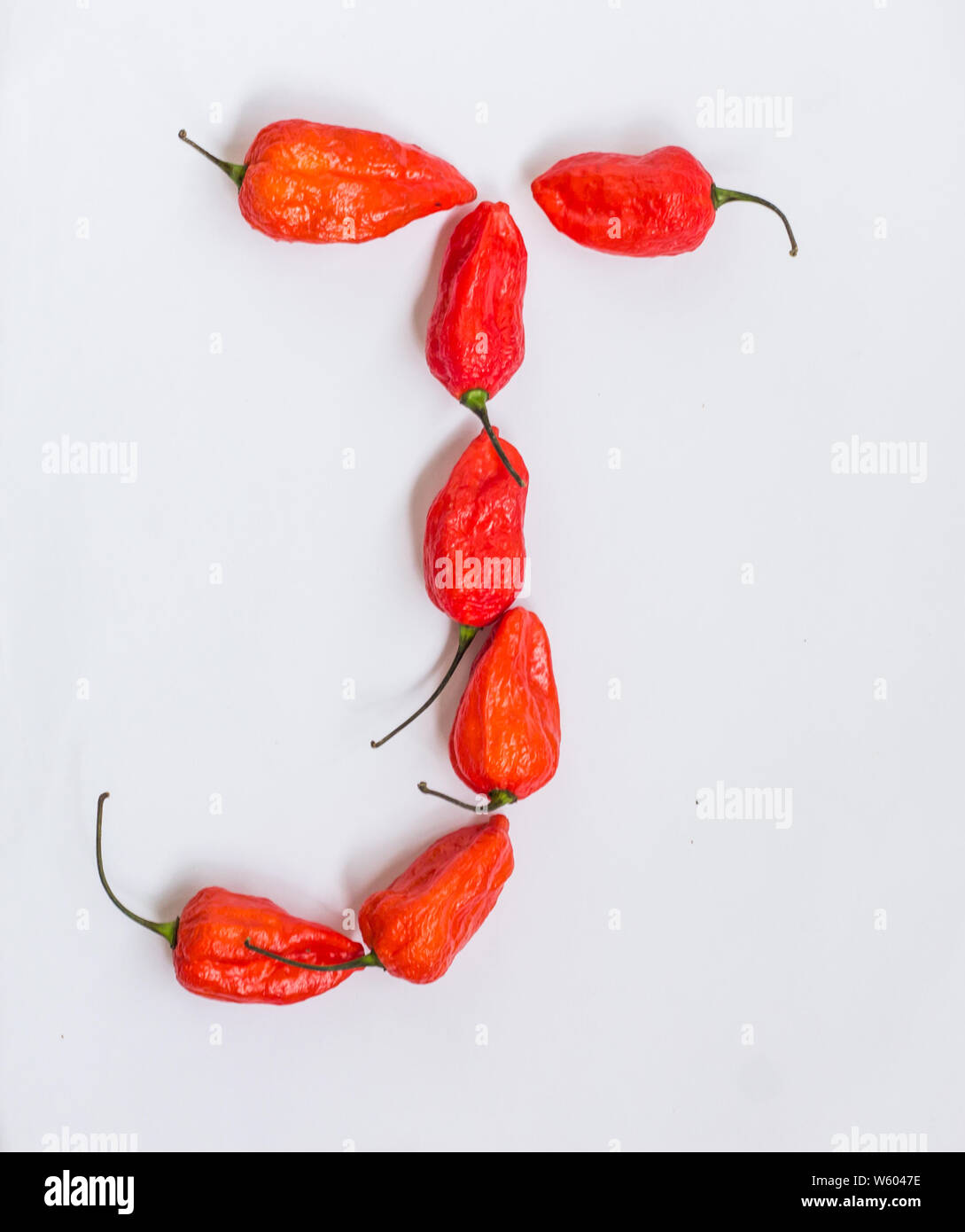 Letter J alphabet made with Ghost pepper Bhoot jolokia over white ...