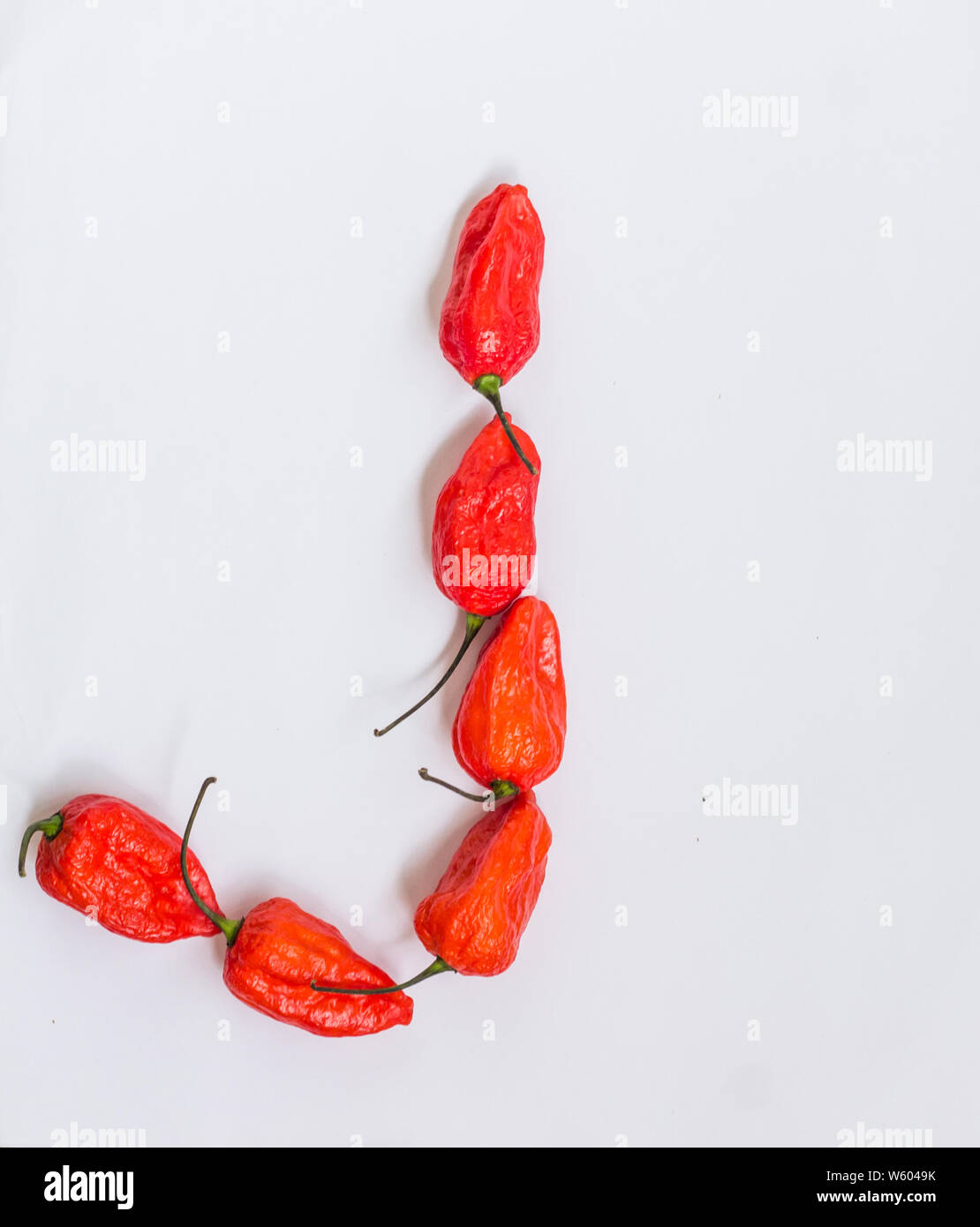 Letter J alphabet made with Ghost pepper Bhoot jolokia over white ...