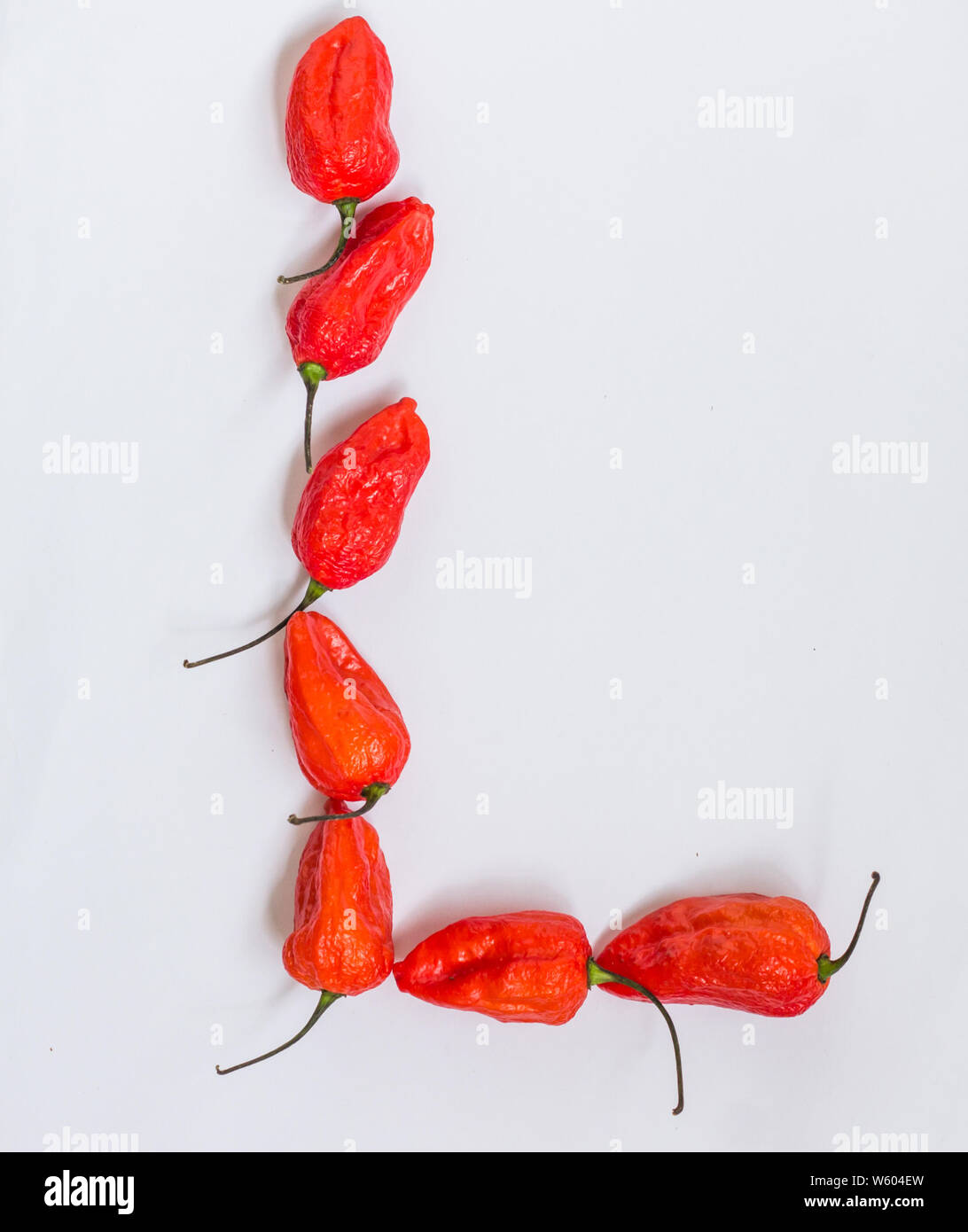 Letter L alphabet made with Ghost pepper Bhoot jolokia over white ...