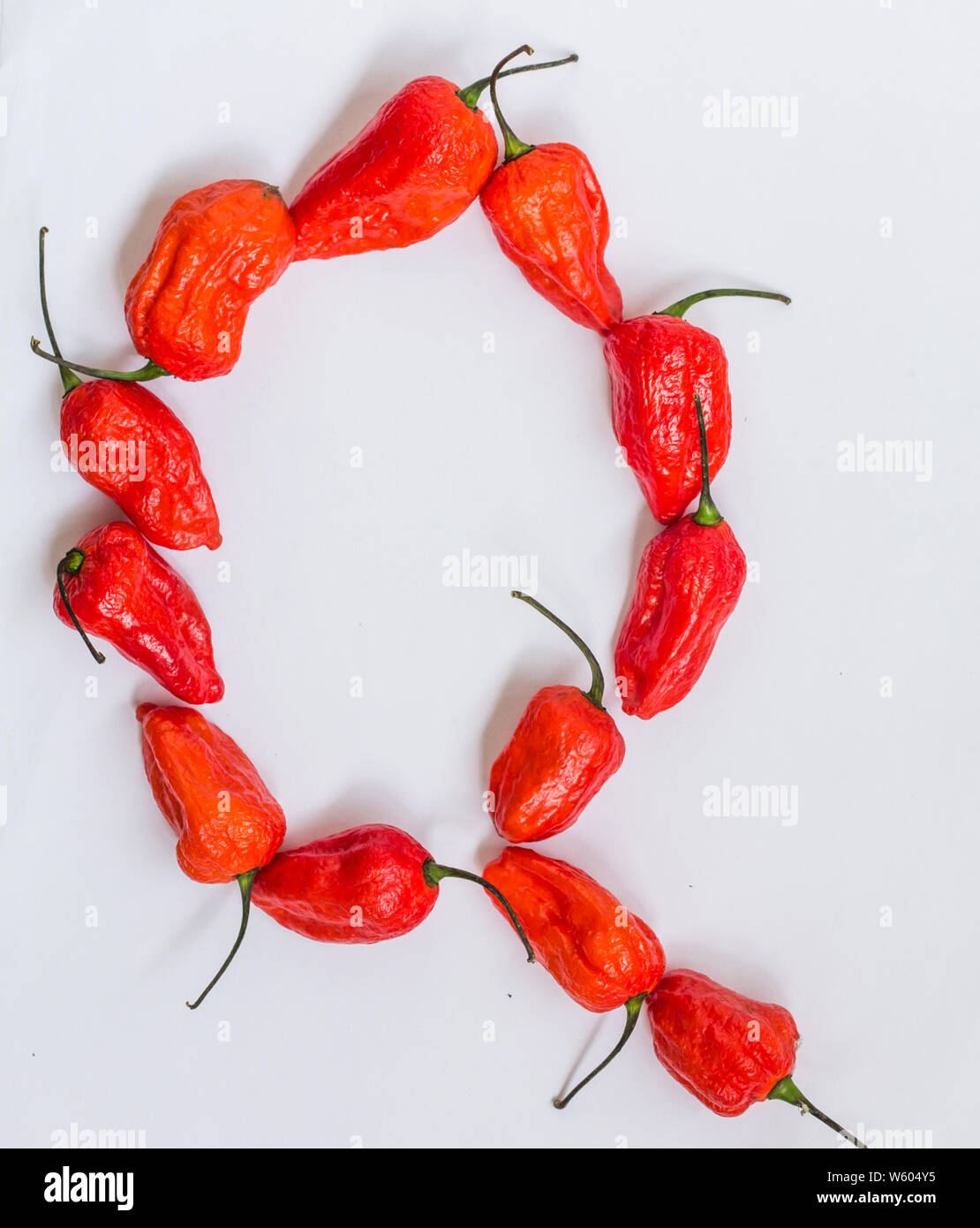 Letter Q alphabet made with Ghost pepper Bhoot jolokia over white ...