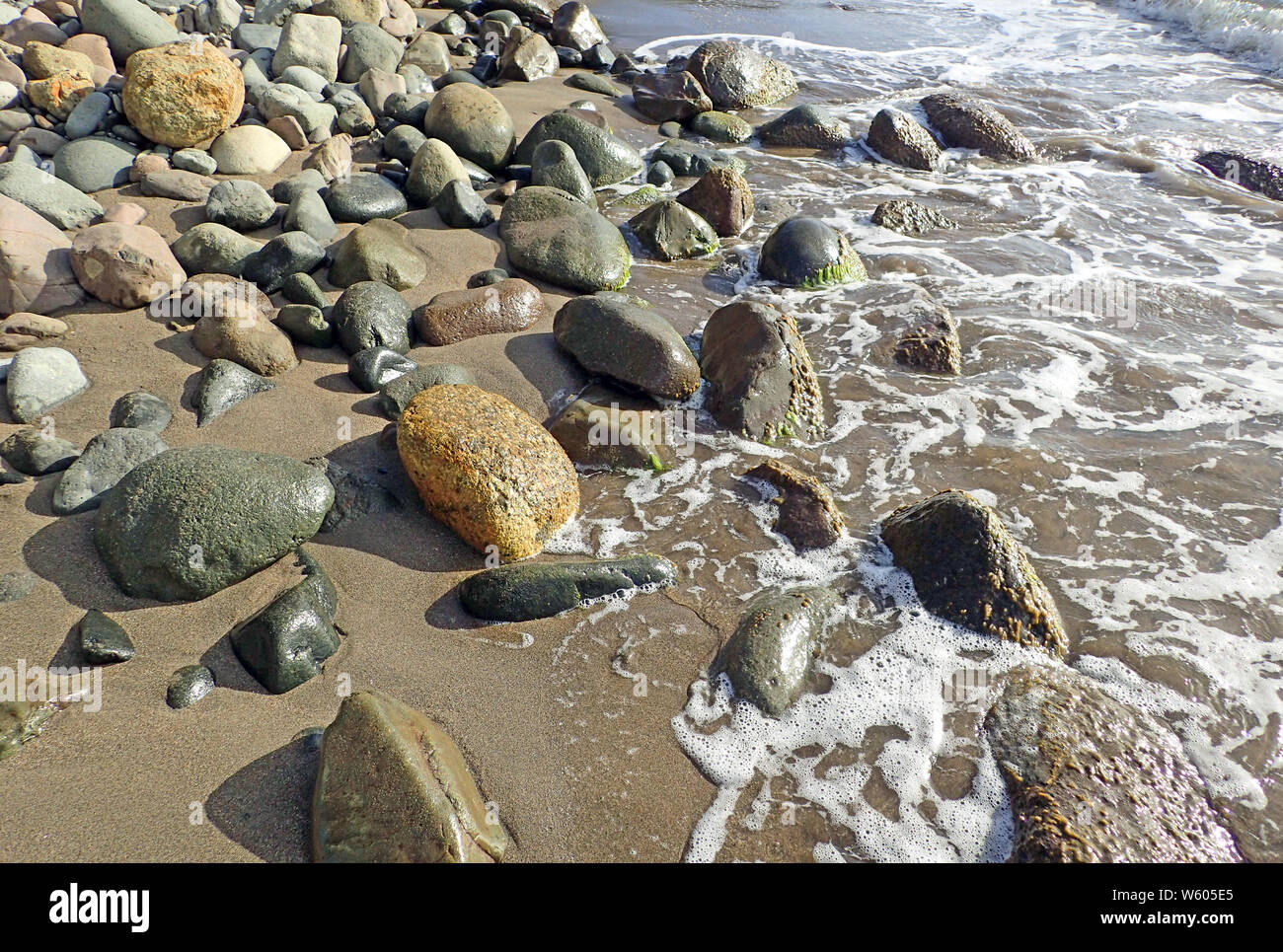 Various shapes and sizes of rocks, stones and pebbles in colors of ...