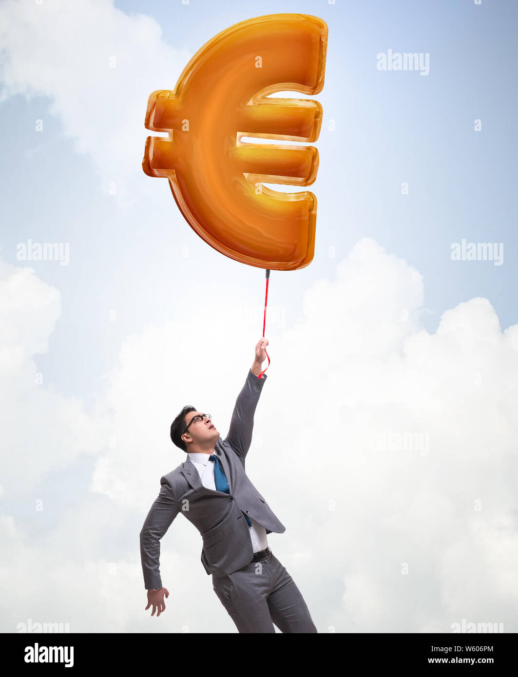 The businessman flying on euro sign inflatable balloon Stock Photo - Alamy