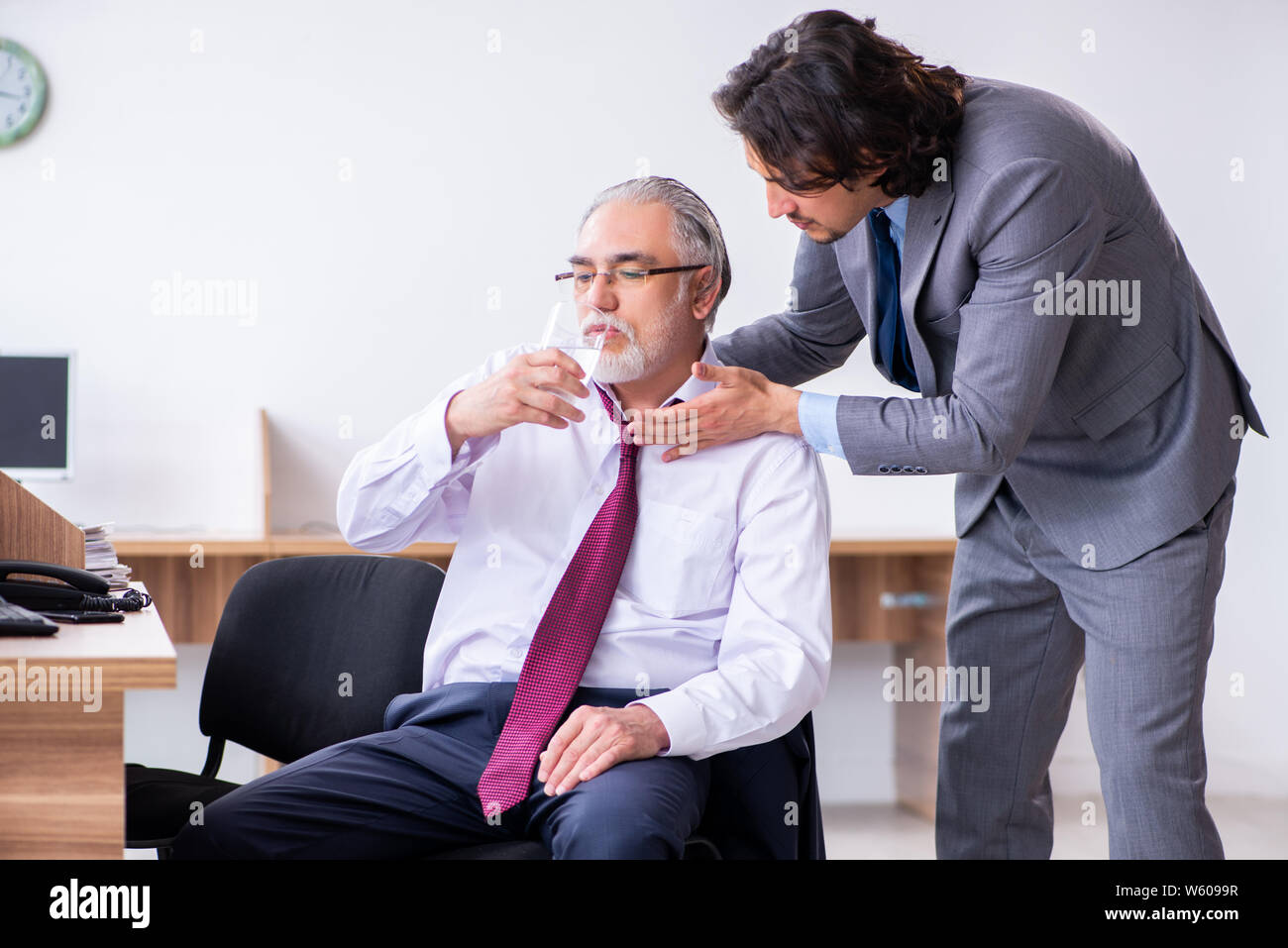 The male employee suffering from heart attack in the office Stock Photo ...