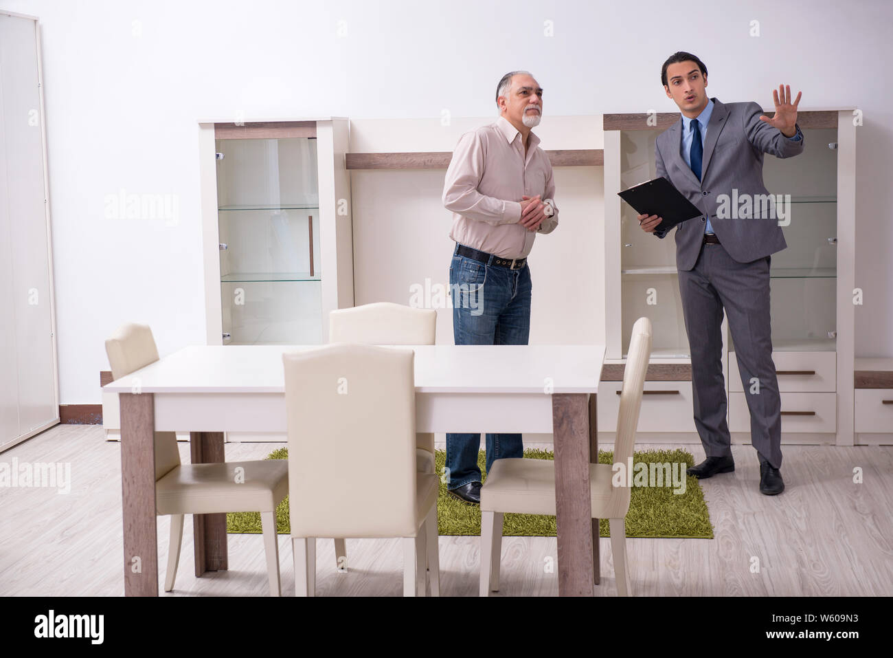 The male real estate agent and male client in the apartment Stock Photo ...