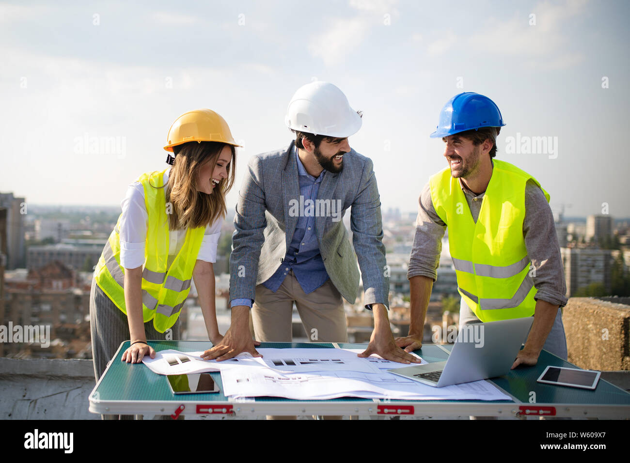 Group of engineers, architects, business partners at construction site ...