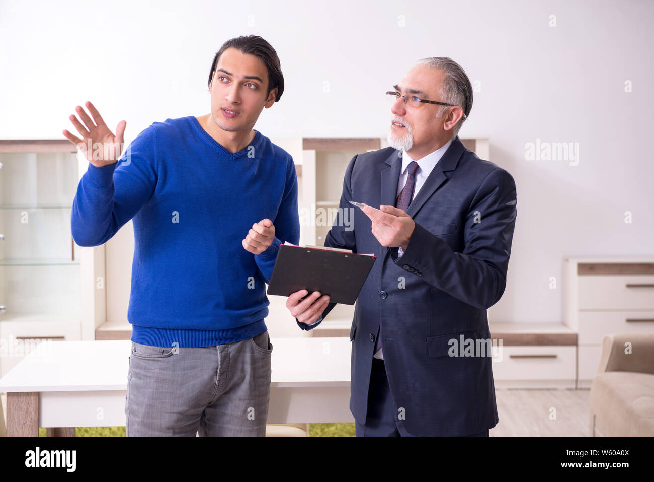 The male real estate agent and male client in the apartment Stock Photo ...