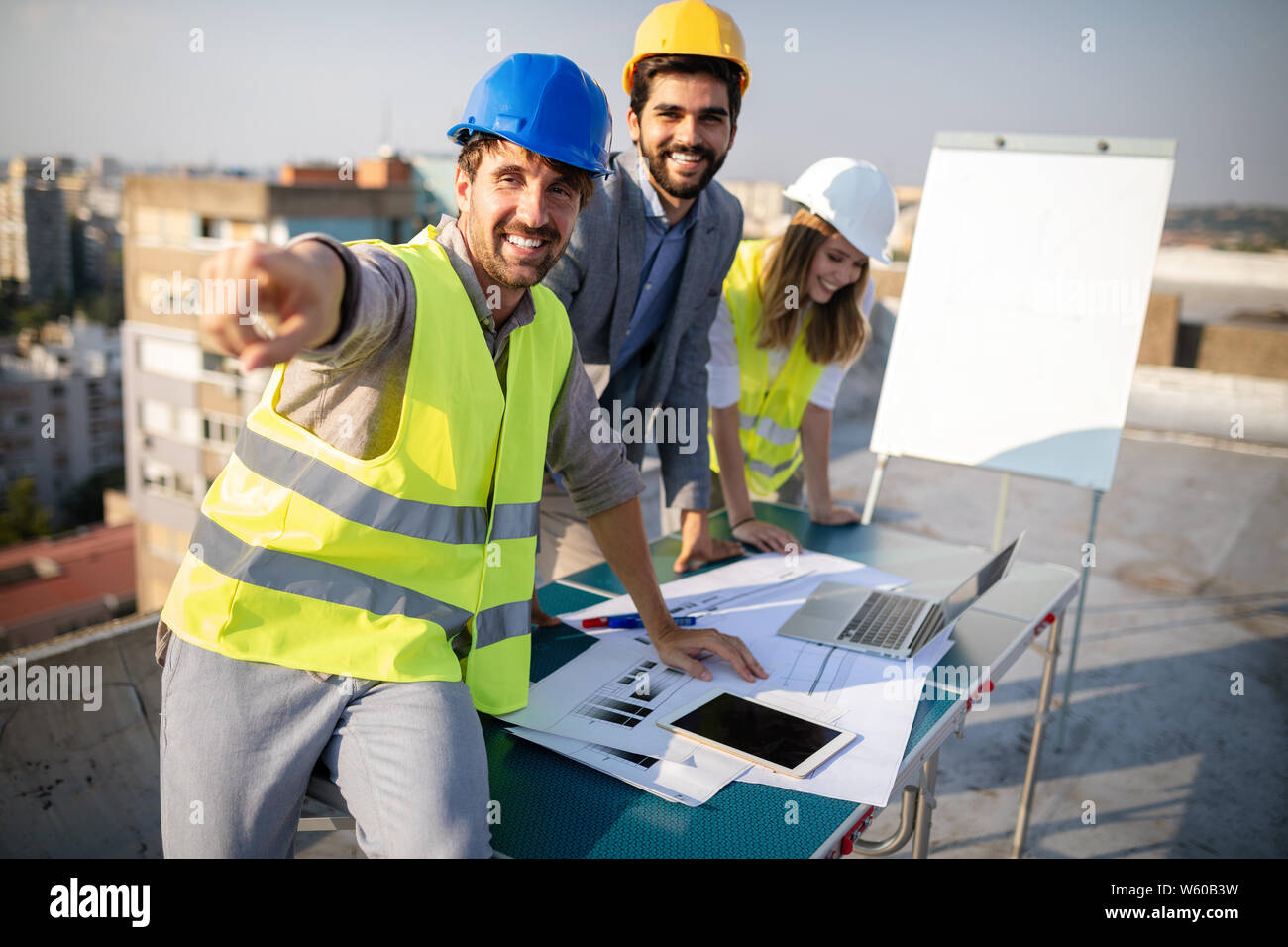 Group of engineers, architects, business partners at construction site ...