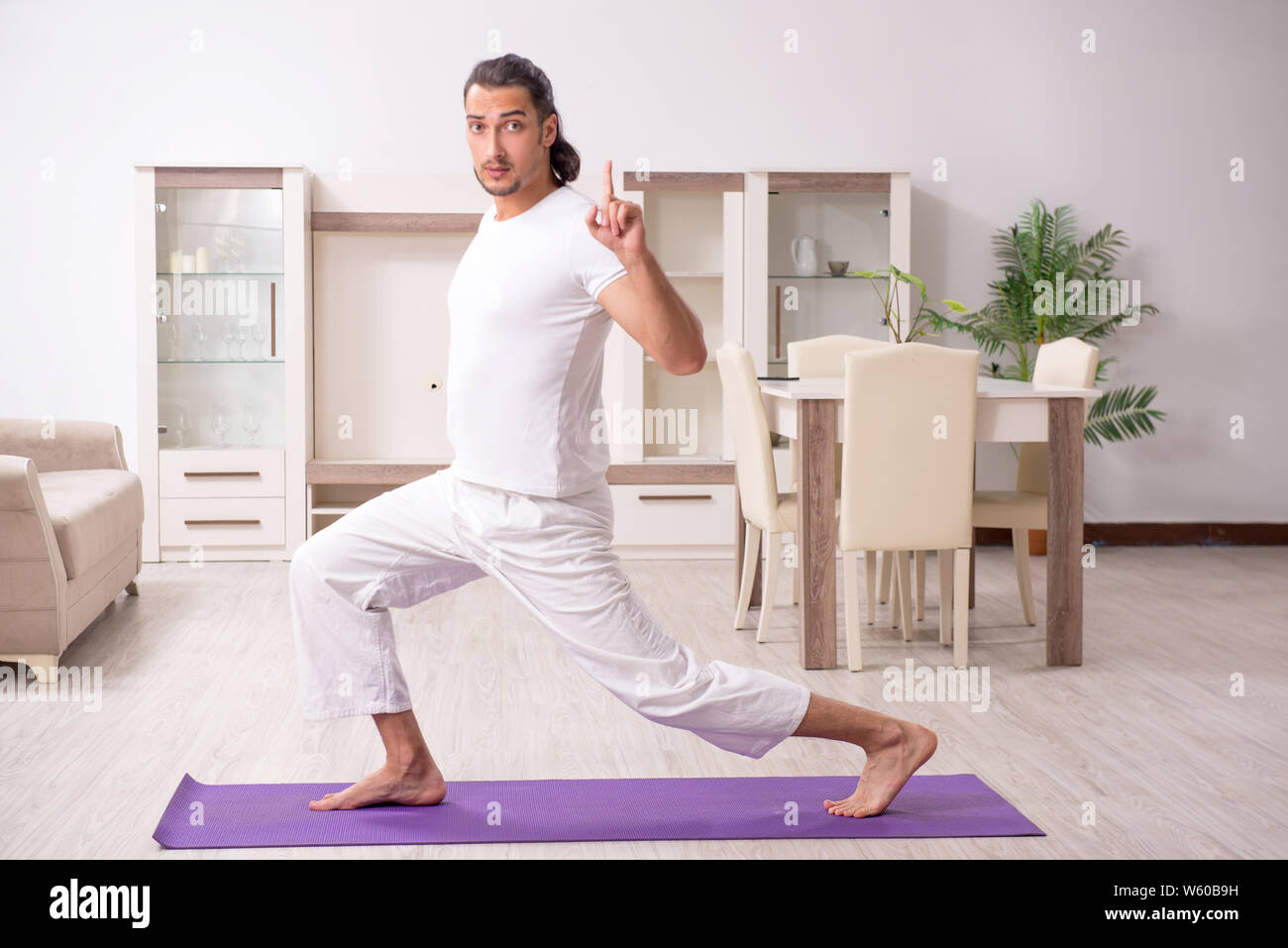 The young man doing physical exercises at home Stock Photo - Alamy