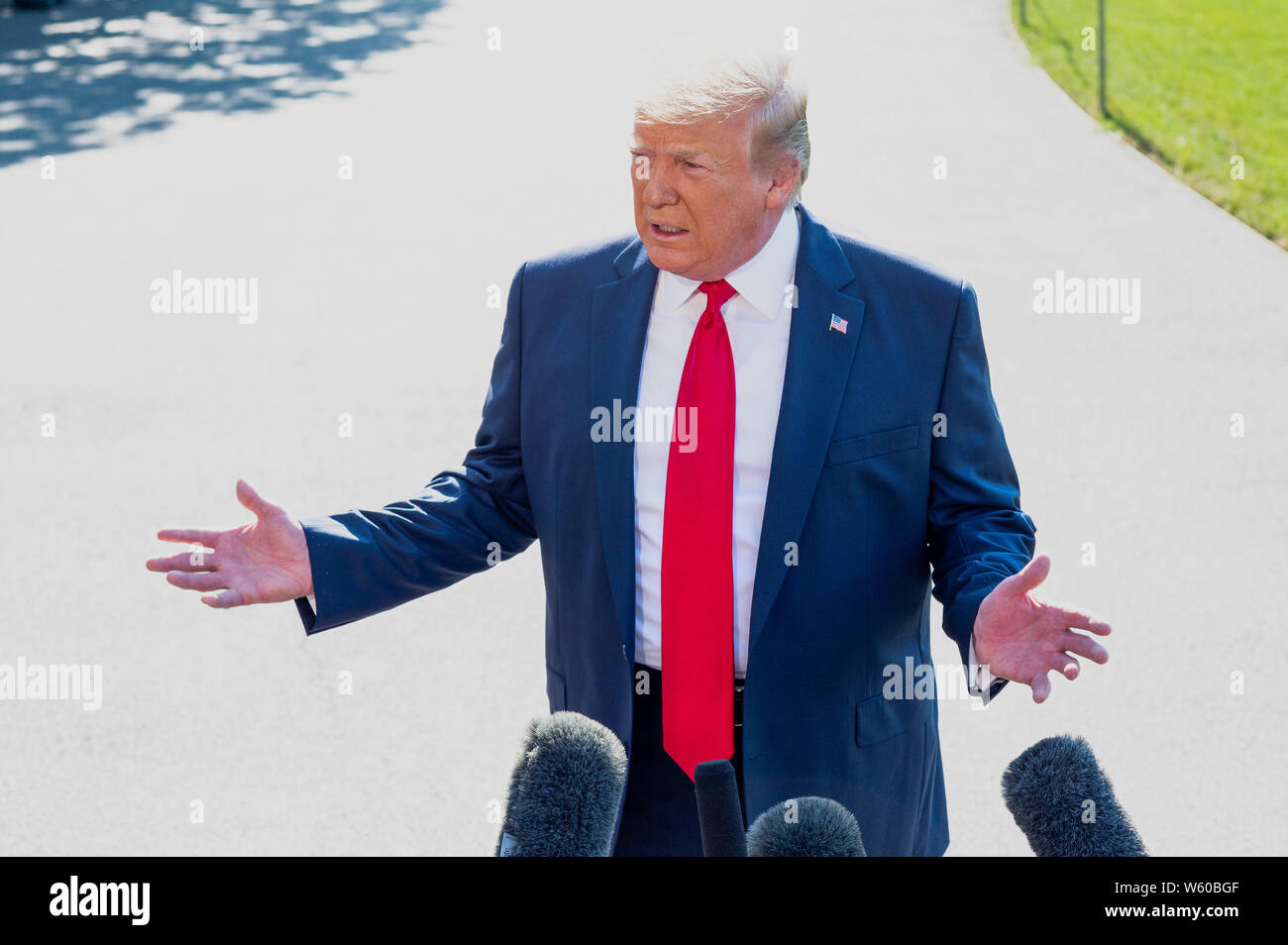 President Donald Trump speaking with the press next to the South Lawn ...