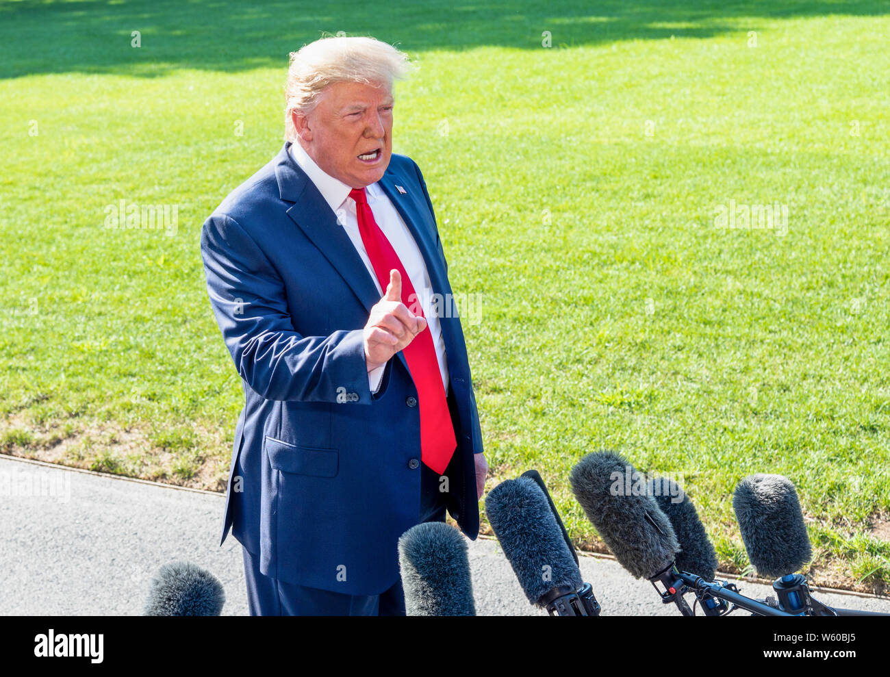 President Donald Trump speaking with the press next to the South Lawn ...