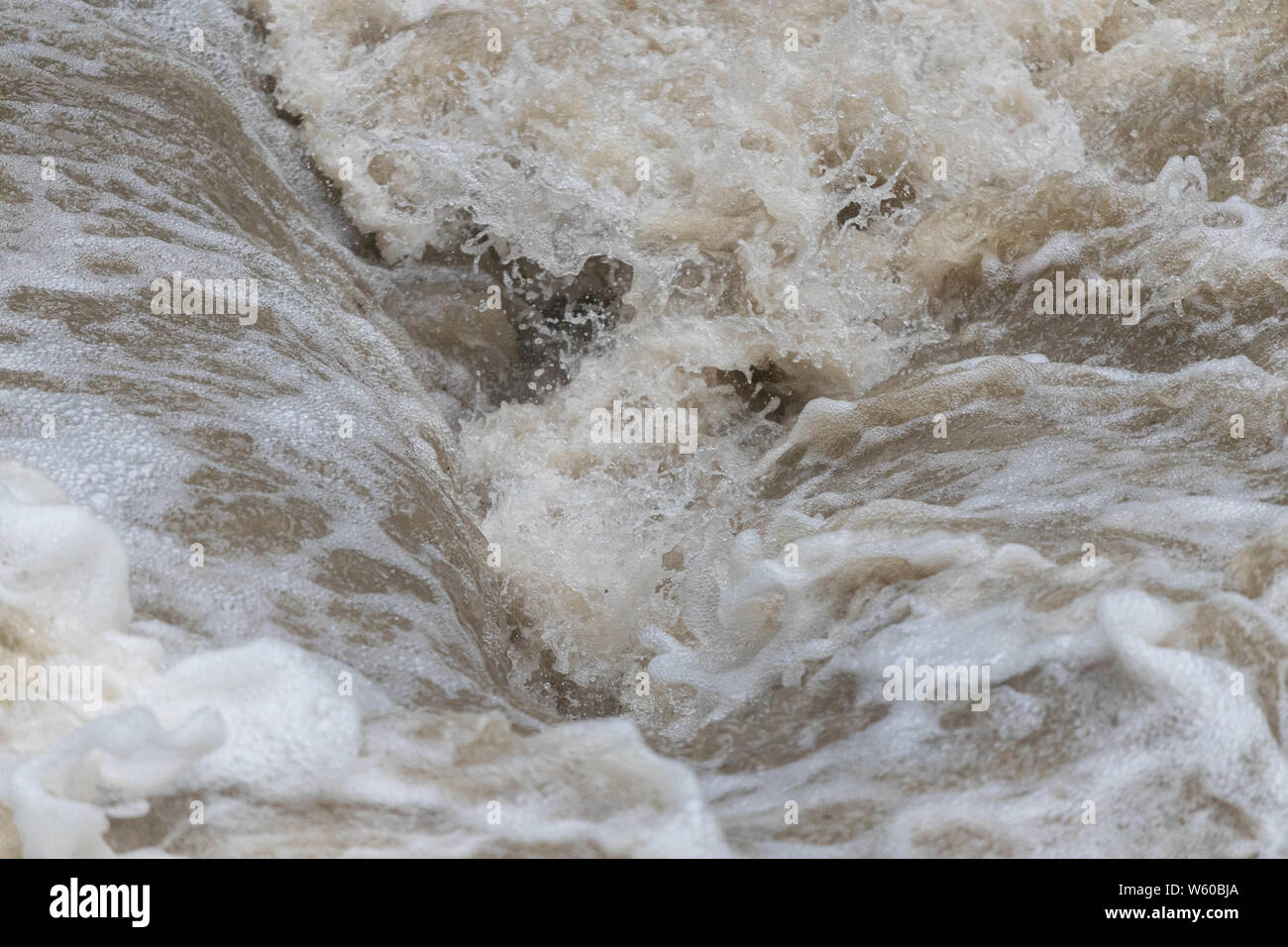 Powerful current flowing over uneven terrain after heavy rain Stock ...