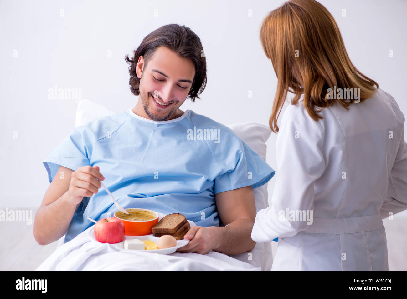The male patient eating food in the hospital Stock Photo - Alamy