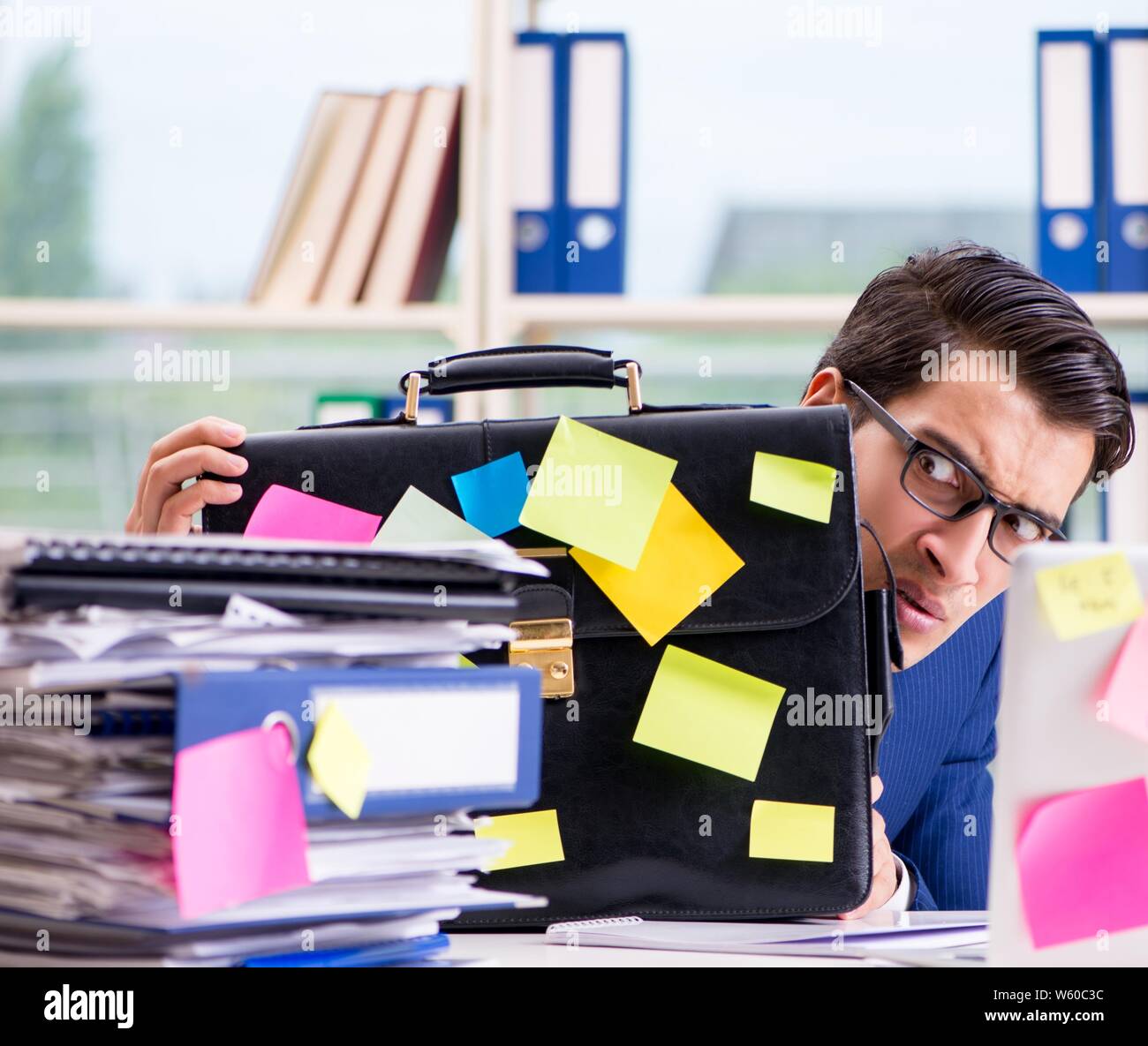 The businessman with reminder notes in multitasking concept Stock Photo ...