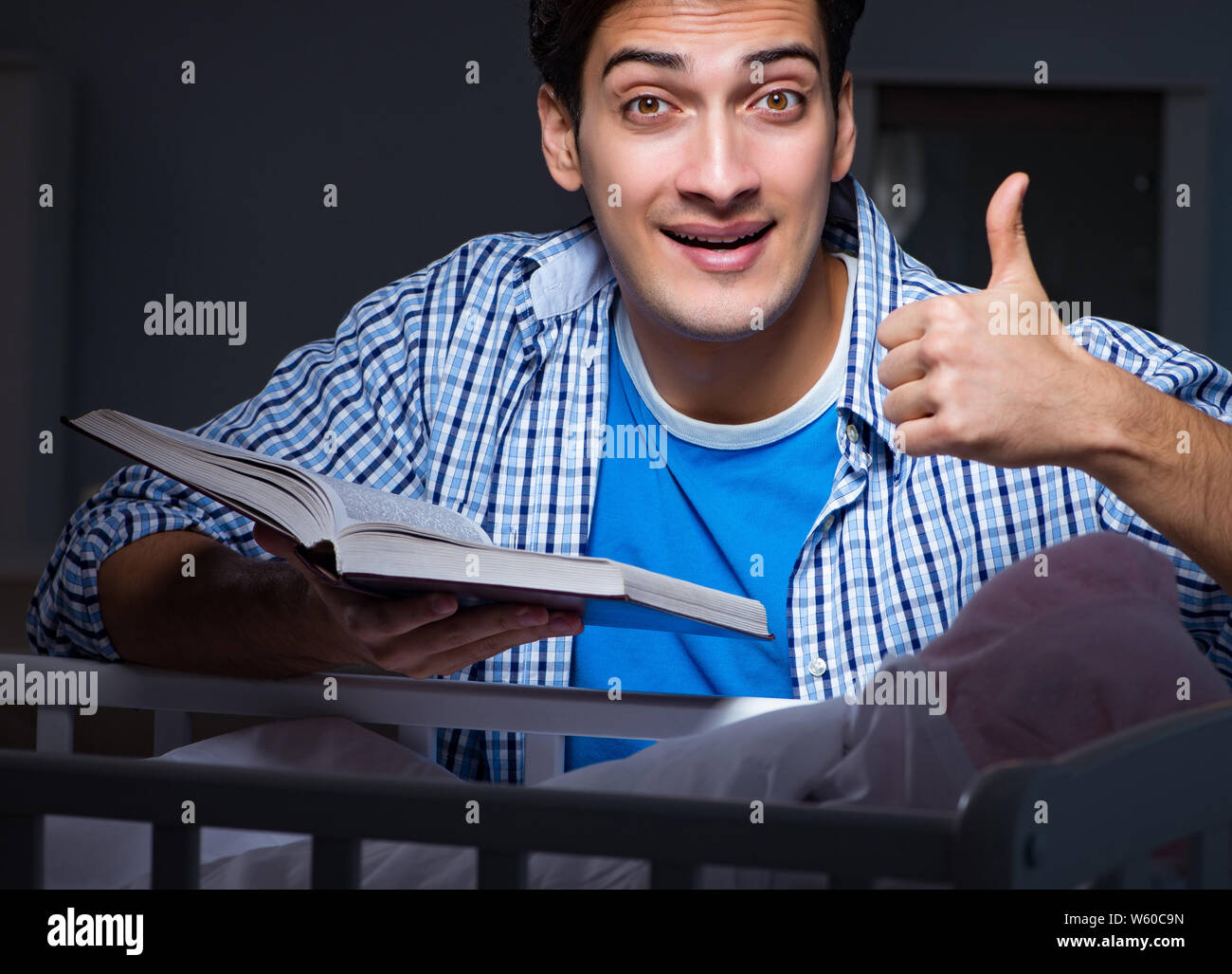 The young student doing homework and looking after newborn baby Stock ...