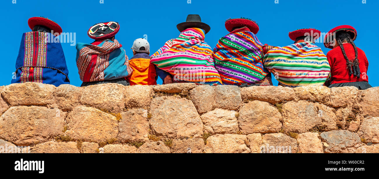 Panorama of Quechua indigenous women in traditional clothing with a boy ...