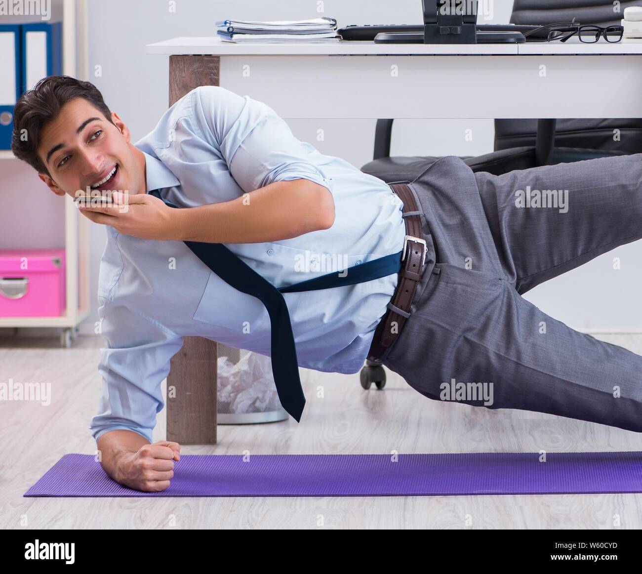The businessman doing sports in office during break Stock Photo - Alamy