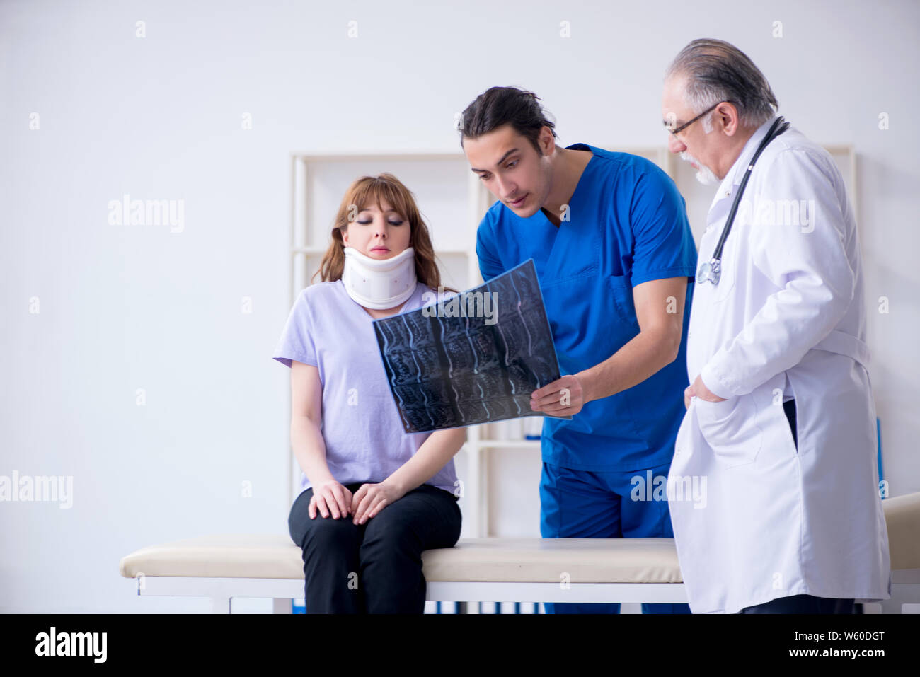 The two doctors examining young woman Stock Photo - Alamy