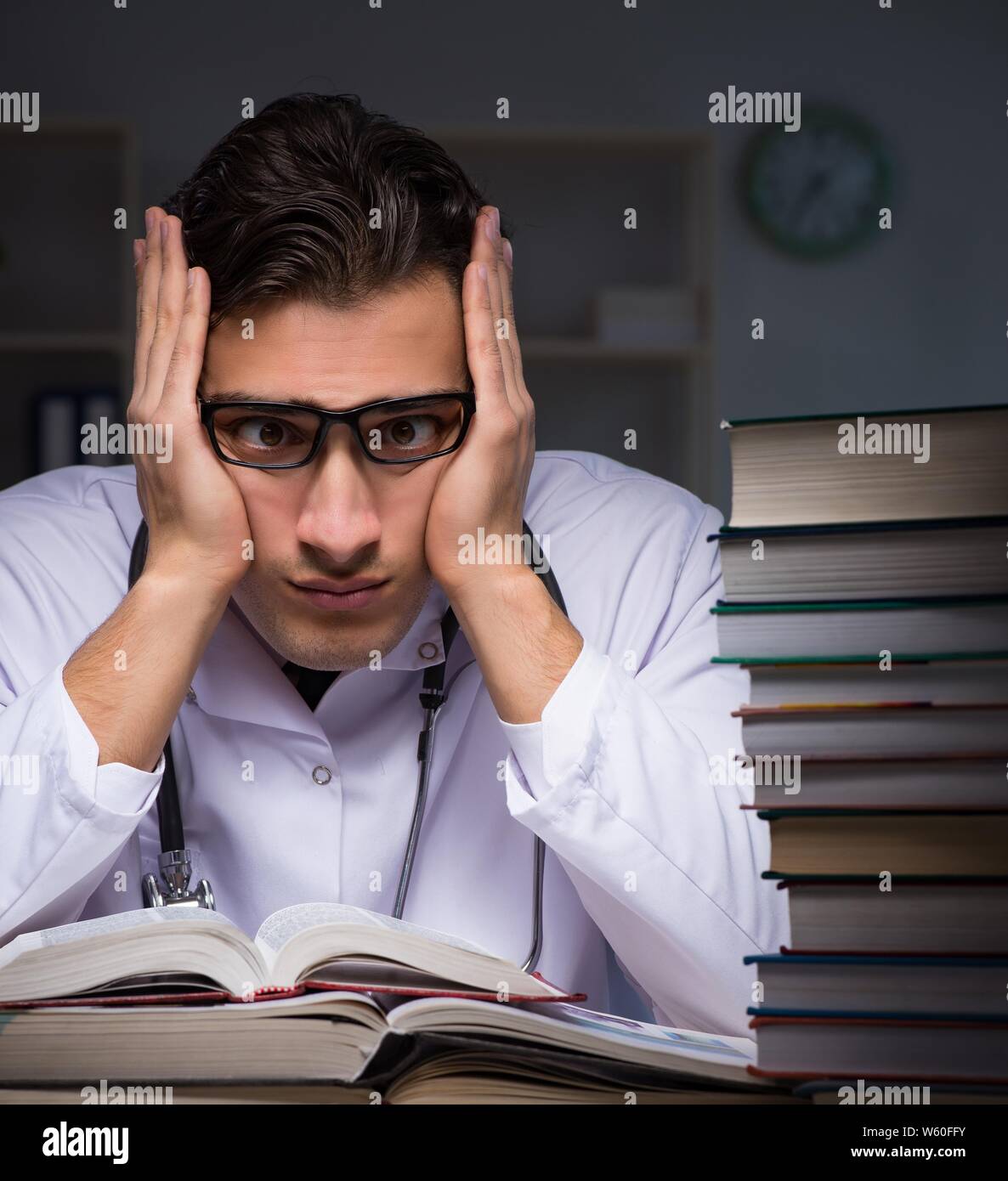 The medical student preparing for university exams at night Stock Photo ...