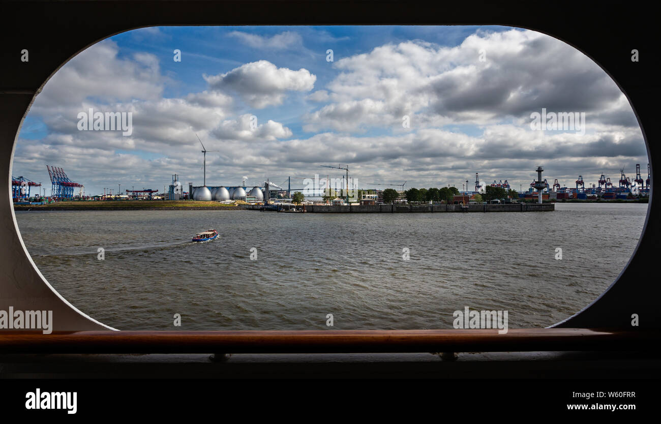 View through cruise port hole of industrial complex on shore line of ...