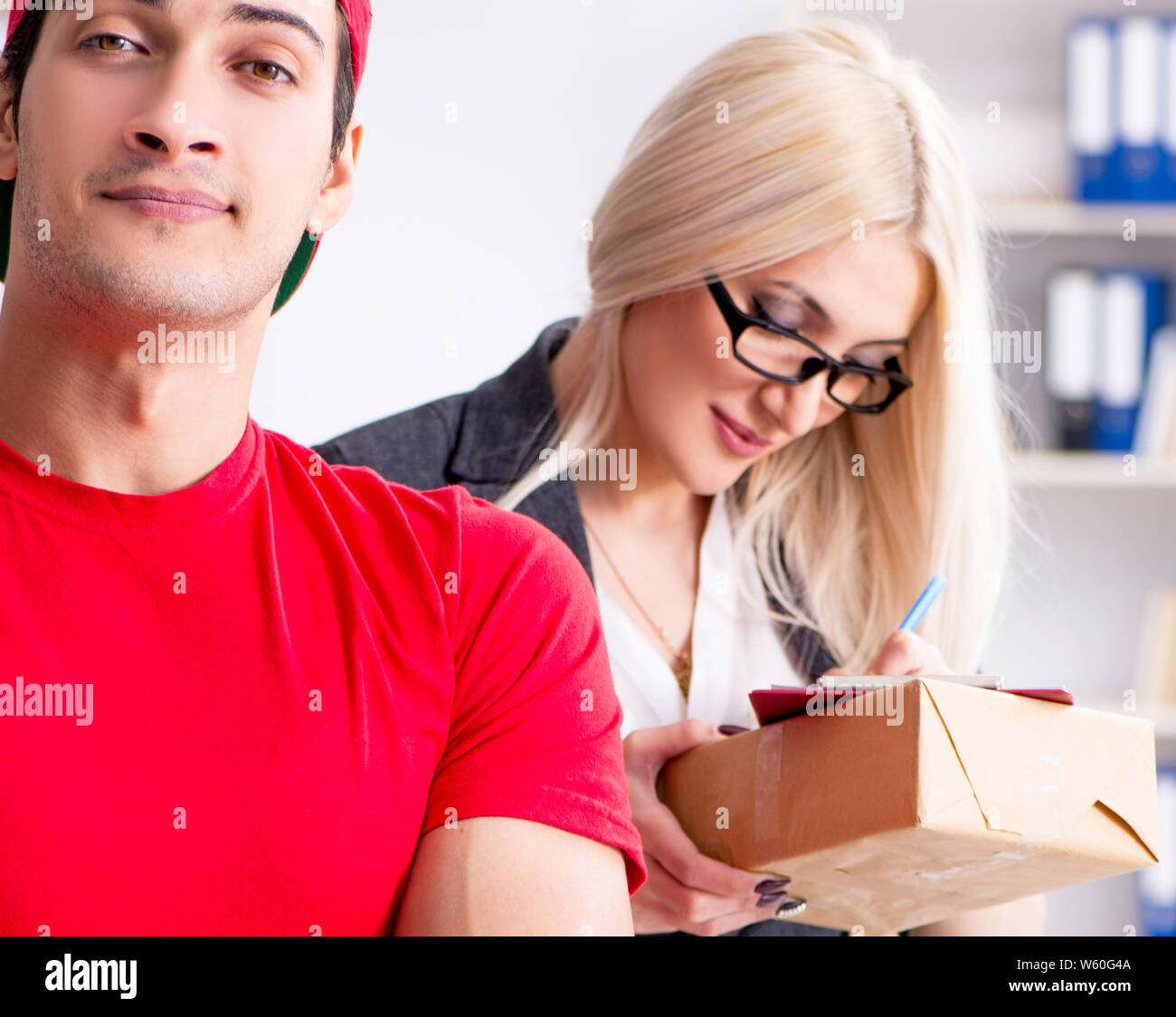 The woman businesswoman receiving mail parcel from courier Stock Photo ...