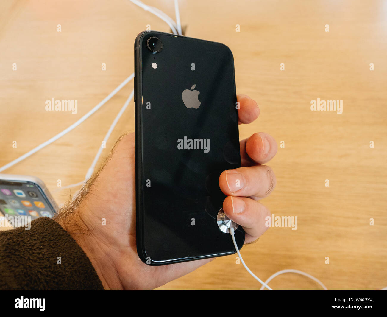 Paris, France - Oct 26, 2018: Man hand holding latest black iPhone XR ...