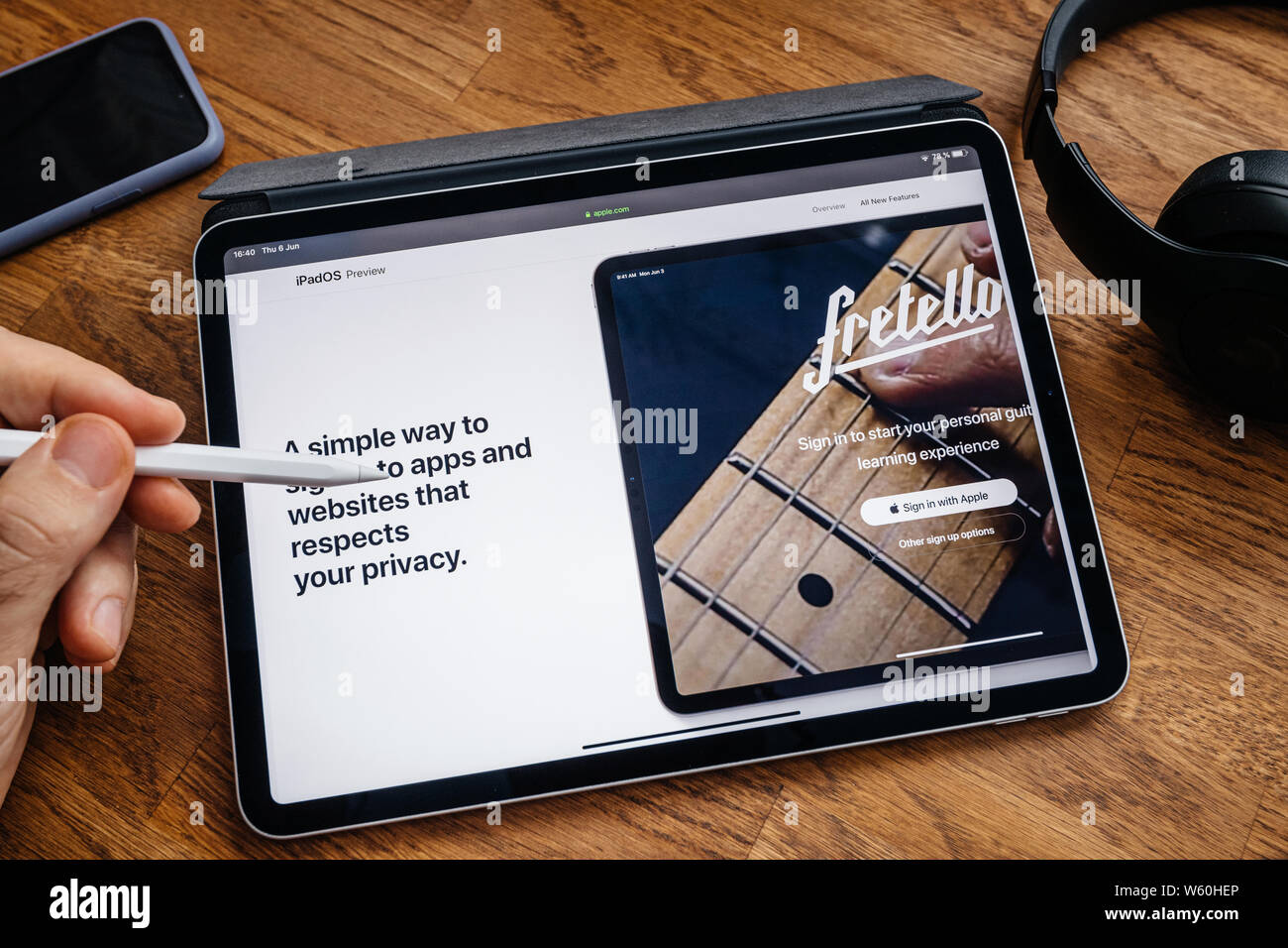 Paris, France - Jun 6, 2019: Man reading on Apple iPad Pro tablet about ...