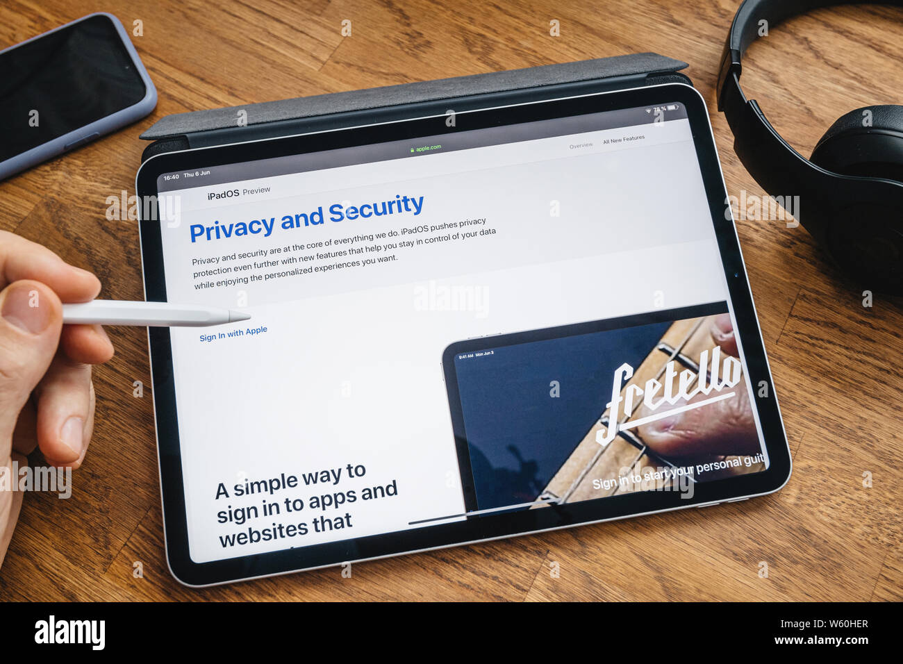 Paris, France - Jun 6, 2019: Man reading on Apple iPad Pro tablet about ...