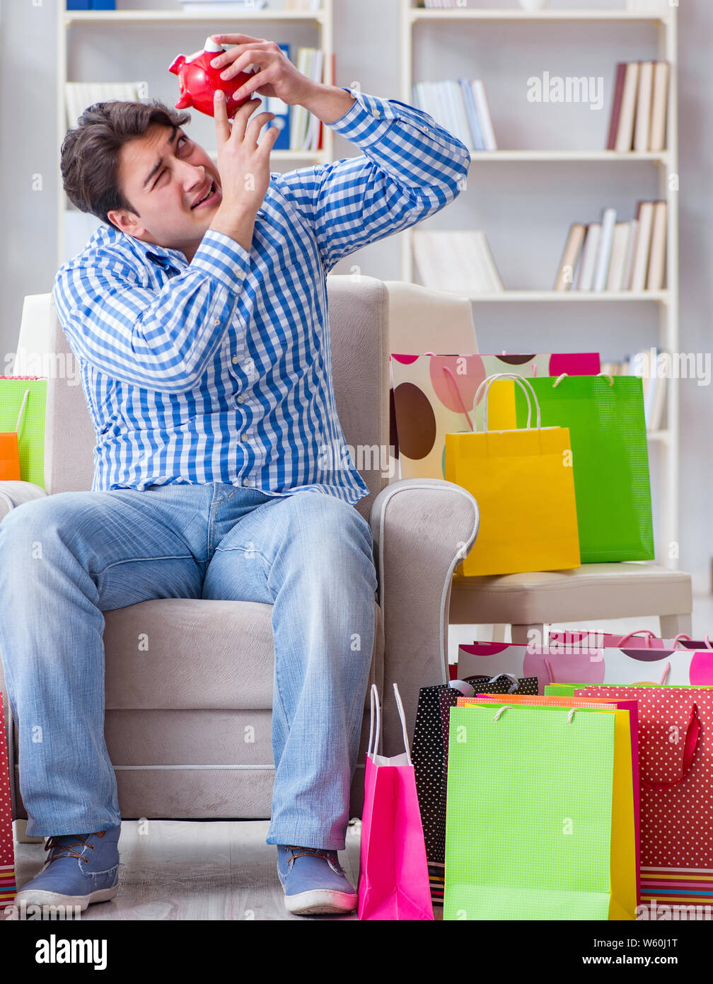 The young man after excessive shopping at home Stock Photo - Alamy