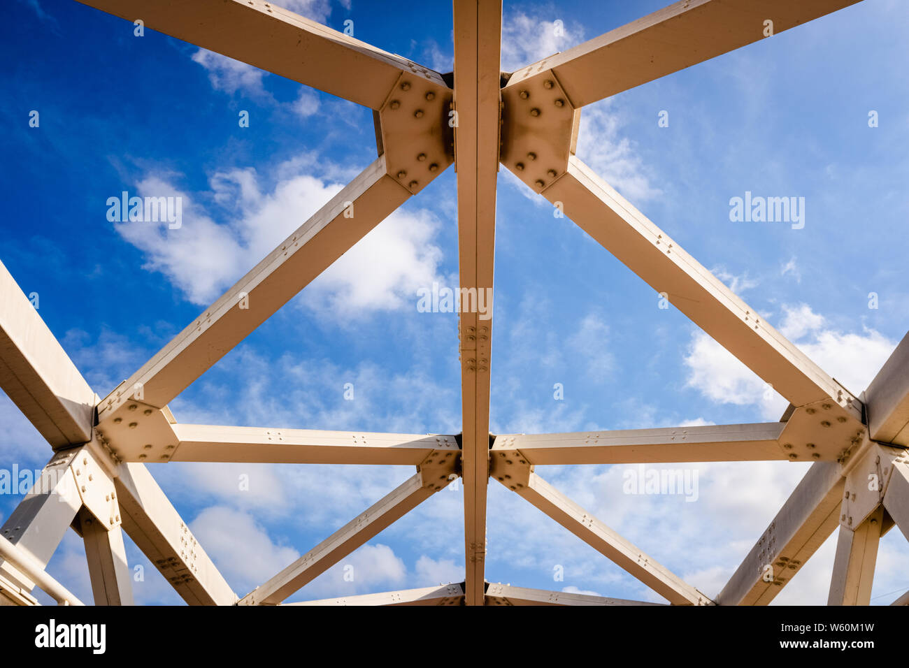 Metal structure of beams joined by screws, against the background sky ...