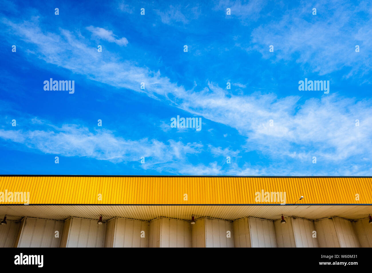 Nice blue sky with clouds, over a yellow canopy of a factory Stock ...