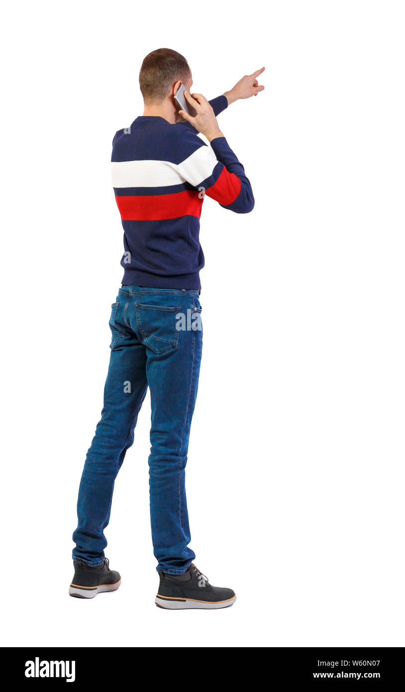 Back view of pointing young men talking on cell phone. Young guy ...