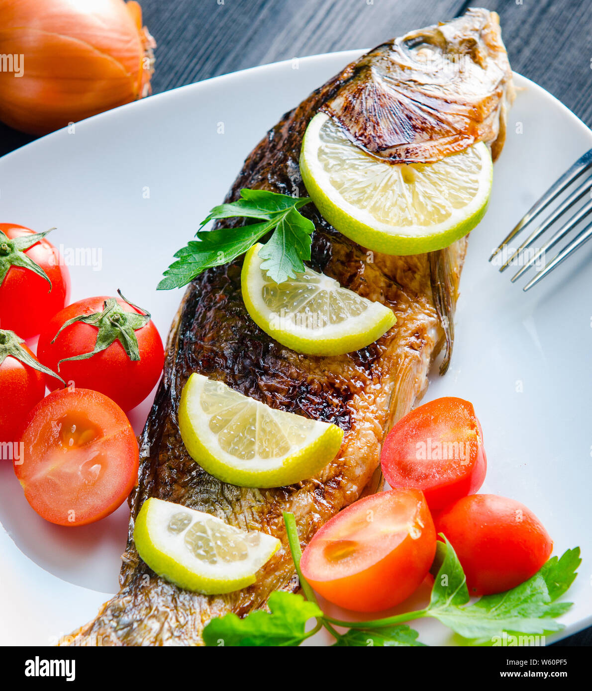 The fried fish served on the plate Stock Photo - Alamy
