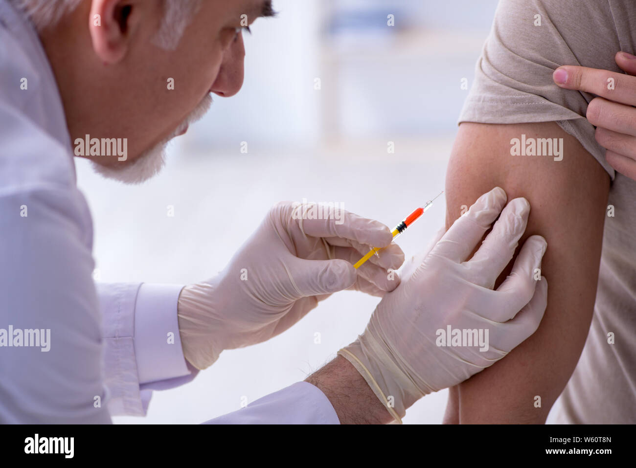 The male patient visitng doctor for shot inoculation Stock Photo - Alamy