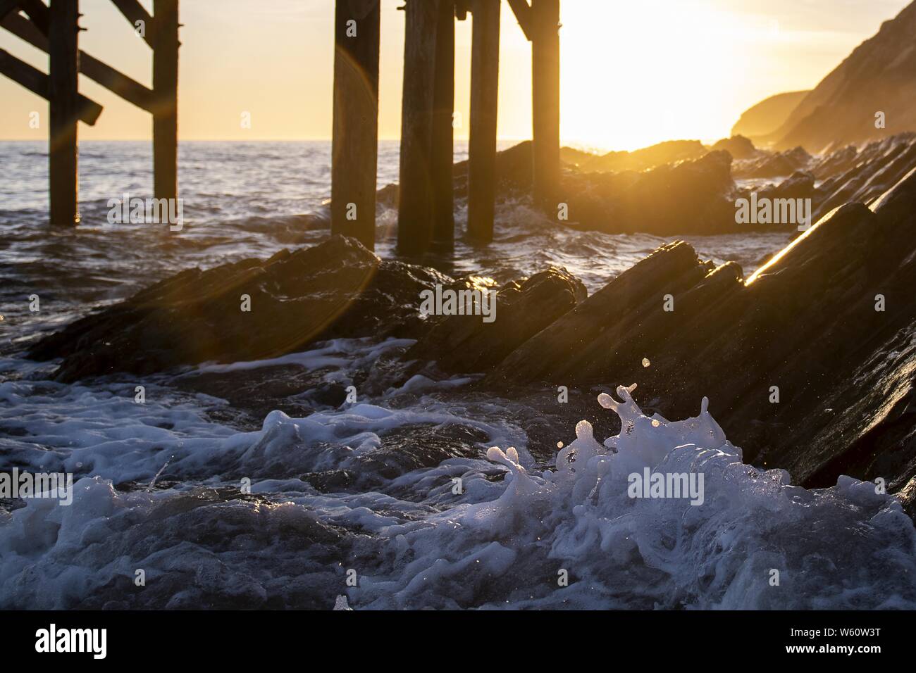 Beautiful ocean waves on spiky rocks at the coast of the sea under the ...