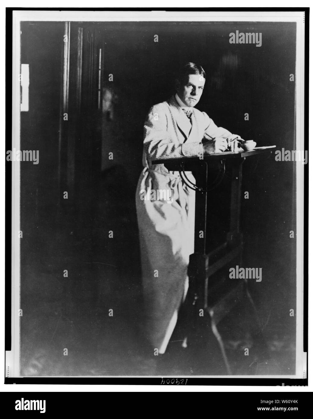 David Graham Phillips, full-length portrait, standing at writing table ...