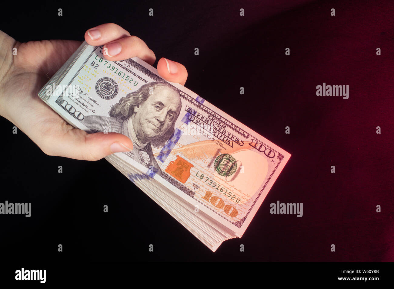 Hand holding American dollar banknotes isolated on white background ...