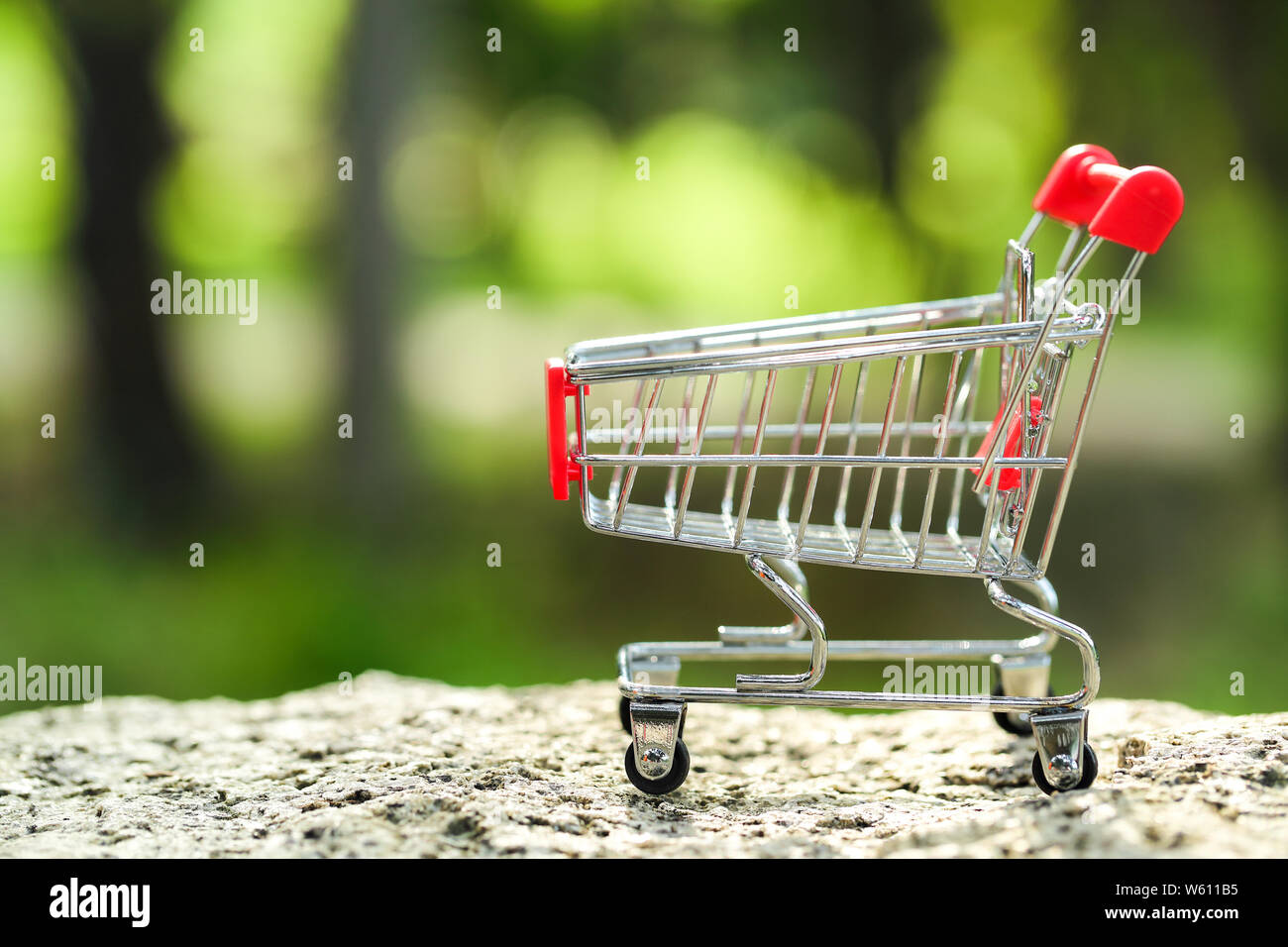 trolley with green background idea for shopping Stock Photo - Alamy