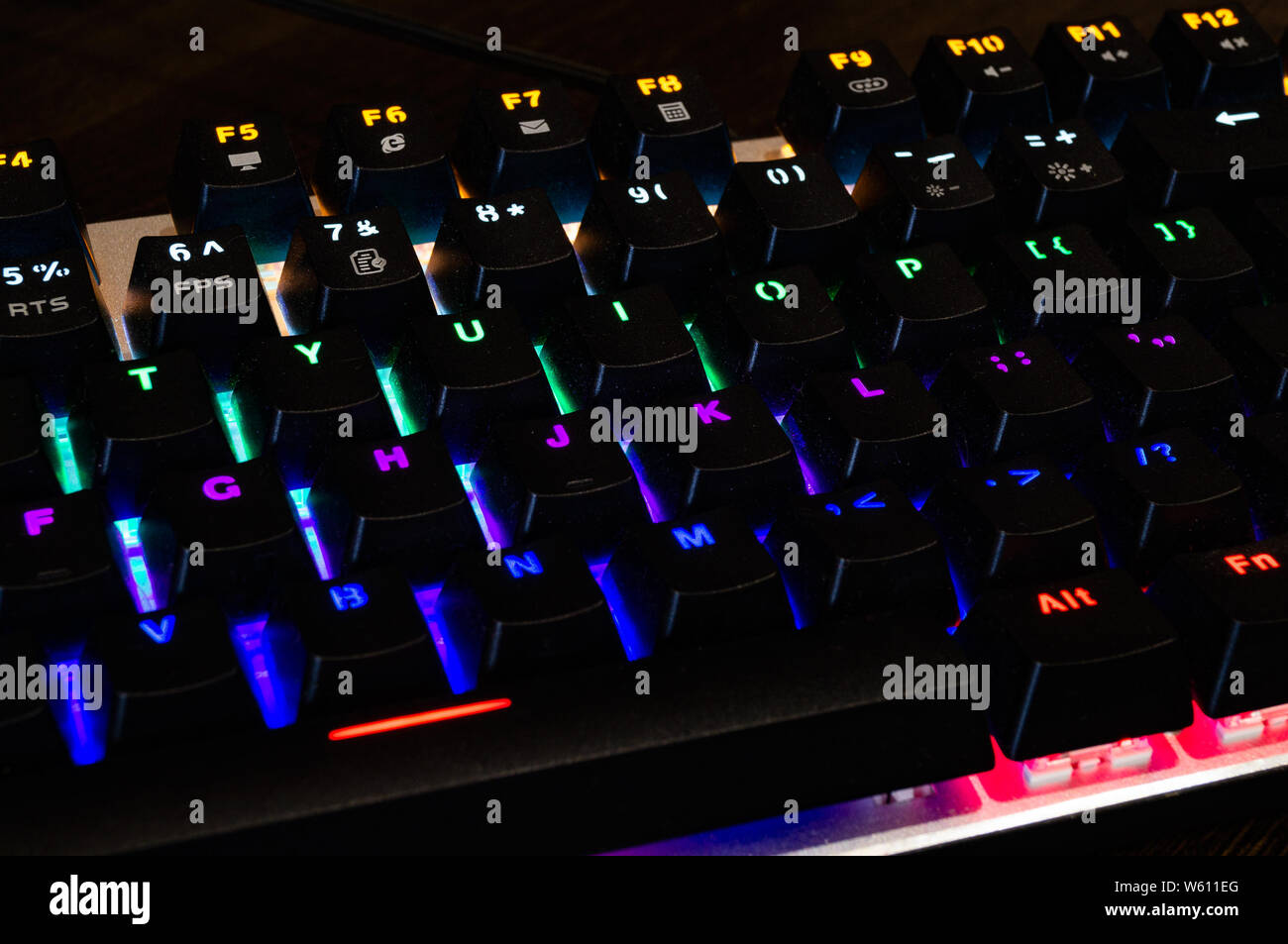 Multi-colored professional gaming mechanical rgb keyboard on the table ...