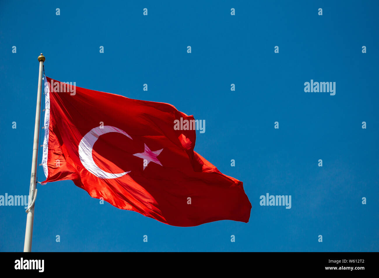 Turkish national flag with white star and moon in sky Stock Photo - Alamy